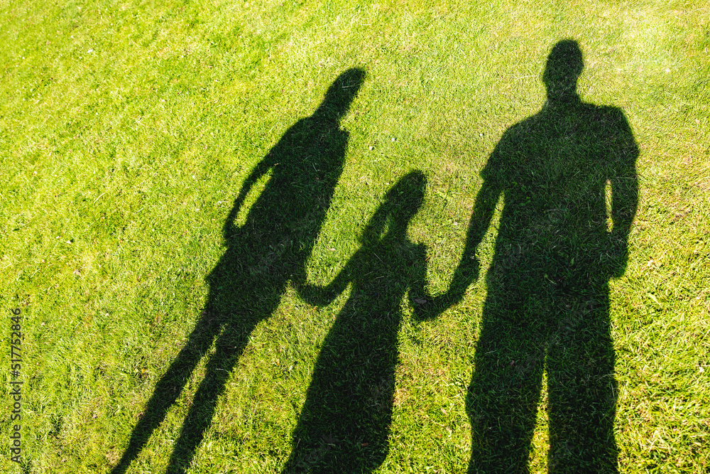 Shadow of family with mother father and daughter together at park Stock ...