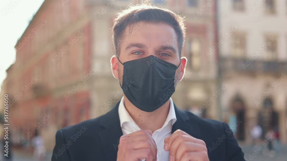 Close up of Caucasian man putting mask on his face to protect himself ...