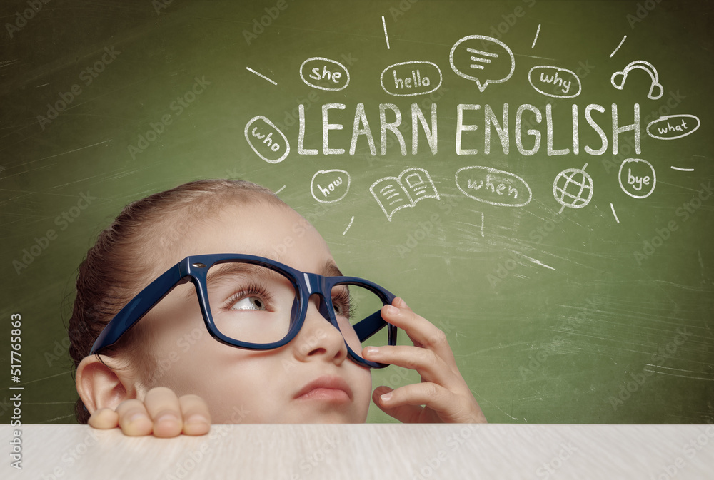 Beautiful cute little girl hiding under table and curiously looking at ...