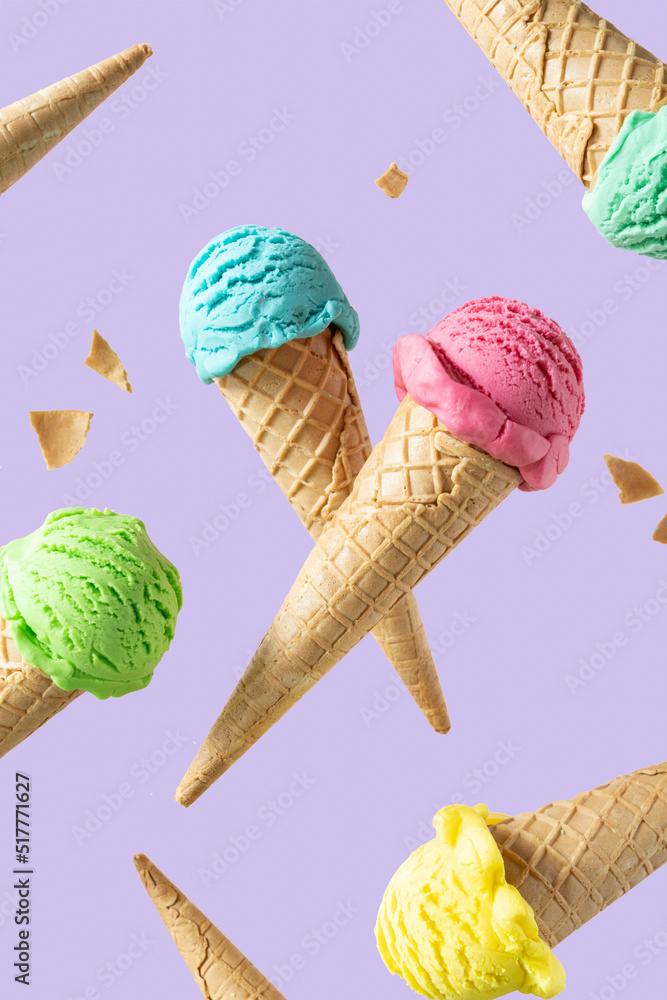 Flying colorful ice cream scoops in cones, bright background ...