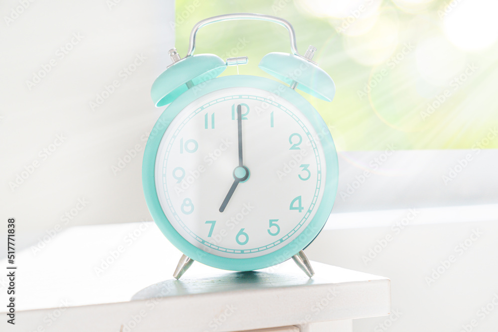 Circadian rhythms concept - alarm clock set on 7 am with sun rays Stock ...