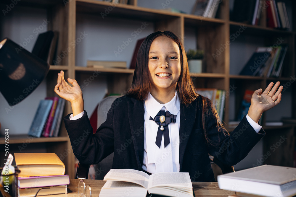 Pretty school girl reading books at the library Stock Photo | Adobe Stock