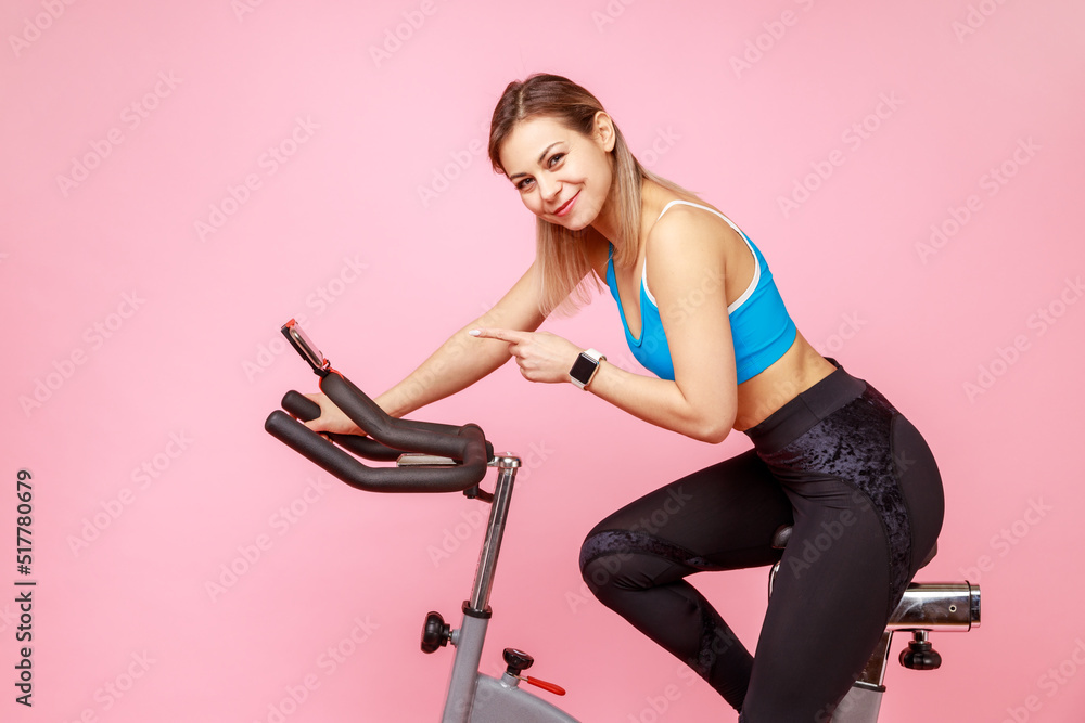 Side view of attractive slim woman having cardio training and ...