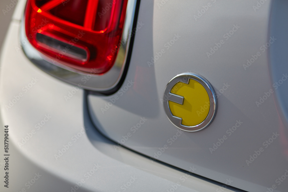 Logo first fully Electric Mini on the rear of the car. The Mini has a ...