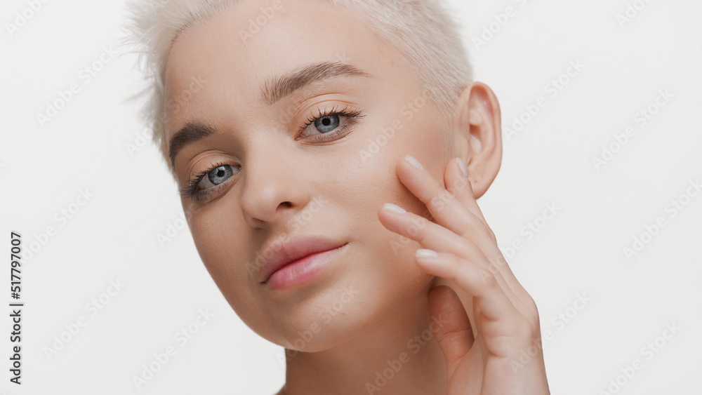 Gorgeous young slim white-haired Caucasian woman looks at the camera ...