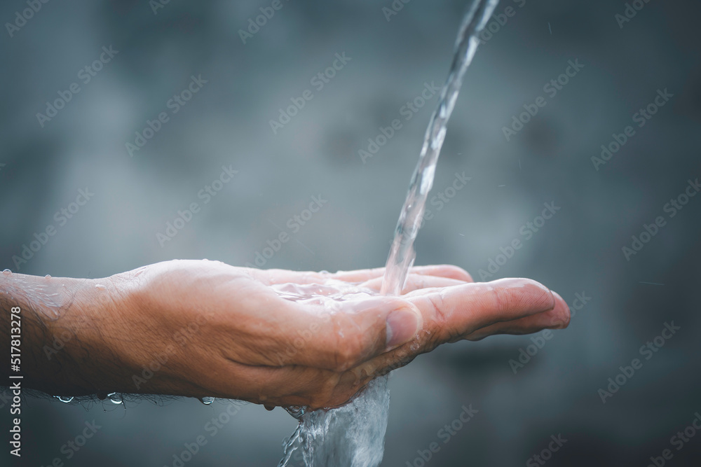 Hands with water splash, in man hand on elegant black background Stock ...