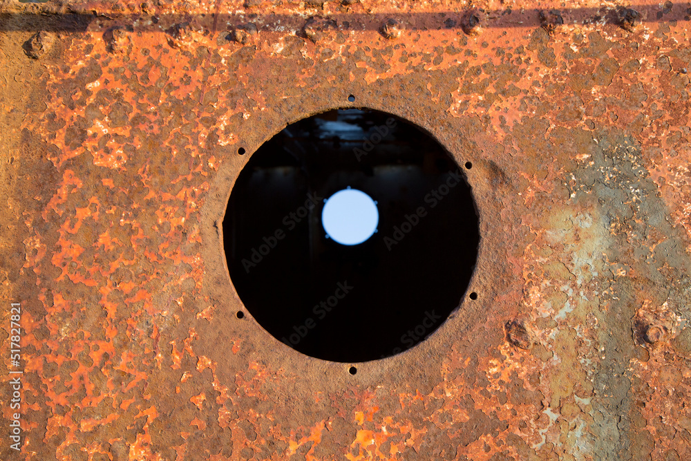 Natural rusty metal texture or background with a round hole and another ...