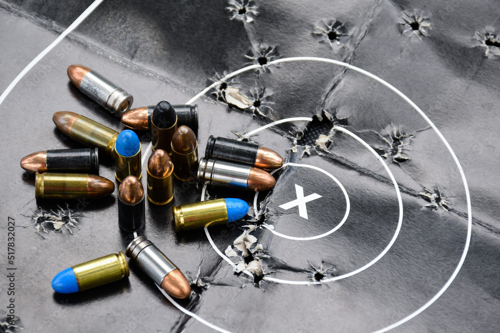 9mm pistol bullets on black leather floor, soft and selective focus on ...