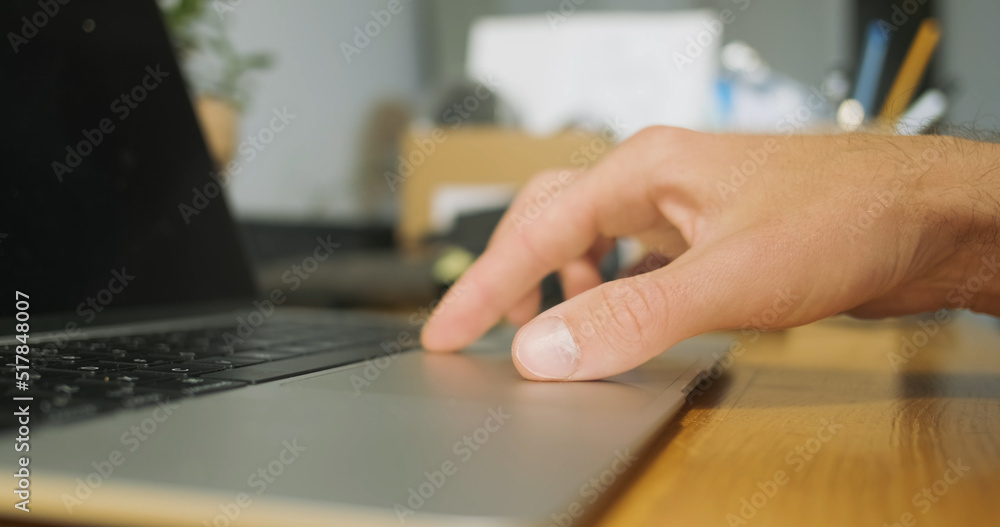 Male hand starts working touchpad of laptop. Click, zoom with your ...