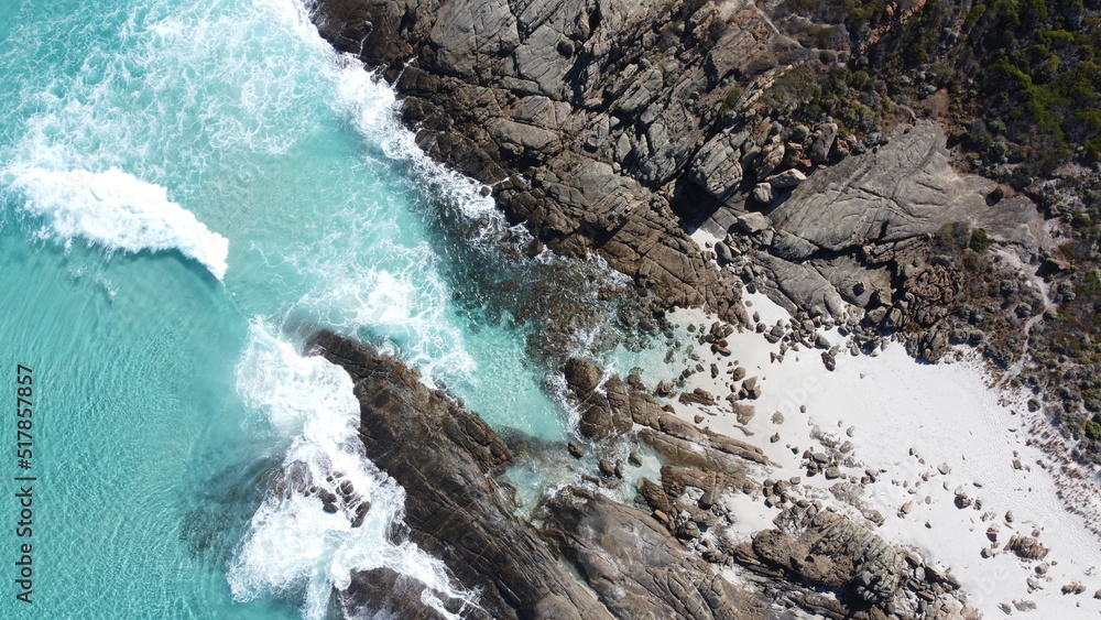 Aerial picture of blue shallow water and rocks at the beach. Location ...