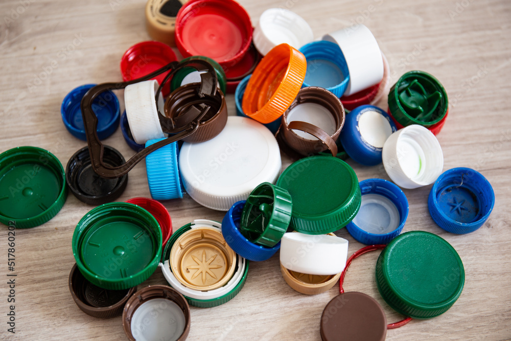 The colored plastic bottle caps. Sorting and processing of garbage and ...