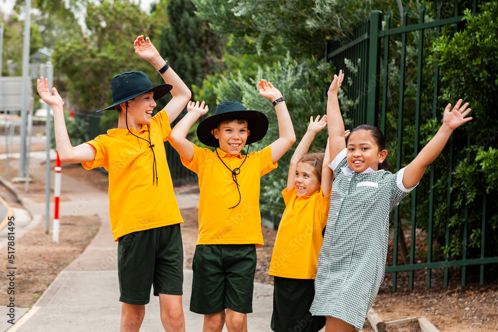Four primary school children celebrating end of term Stock Photo ...