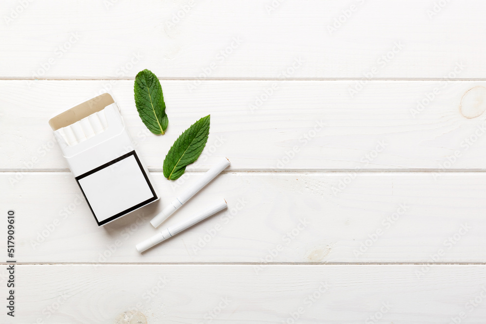 Pack of menthol cigarettes and fresh mint on colored table, Menthol ...