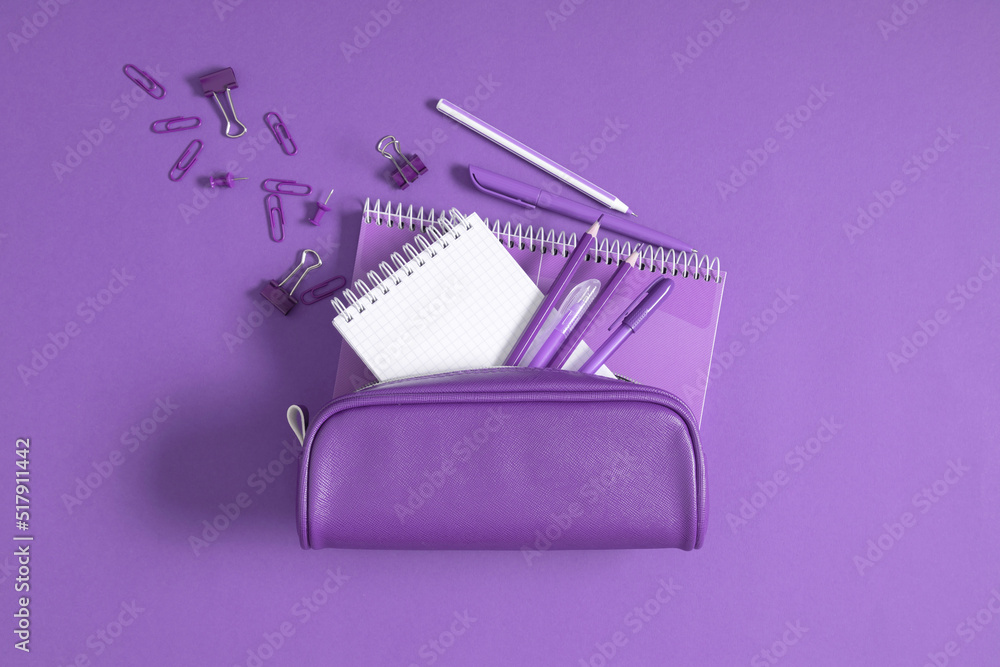Back to school. Purple pencil case with pencils and notebooks on purple ...