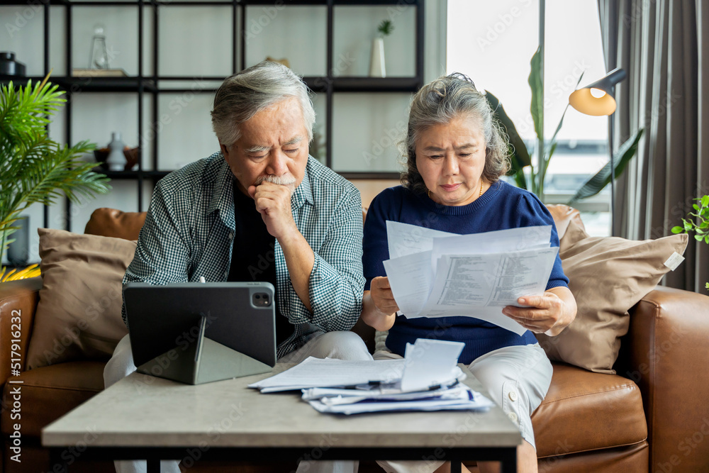 old retired asian senior couple checking and calculate financial ...