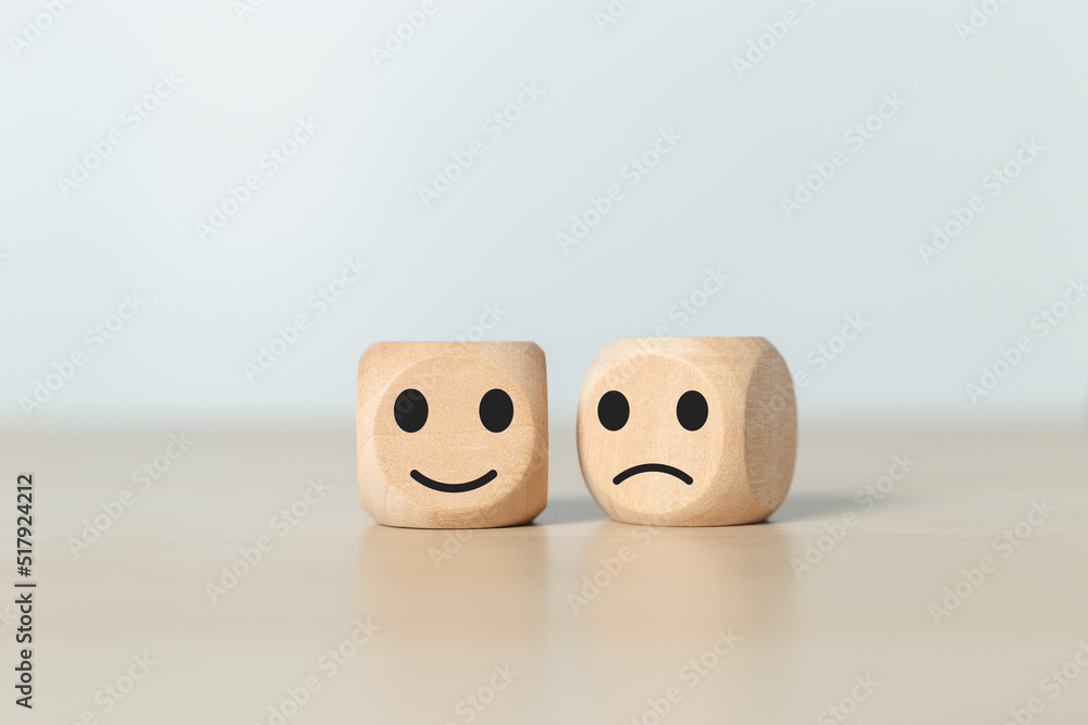 face emotion positive and negative concept. wooden cube with smiley ...