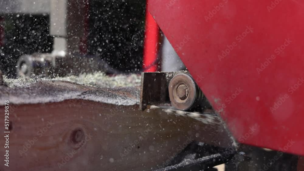 Zoomed in clip of the moving mechanical parts of a band saw mill ...