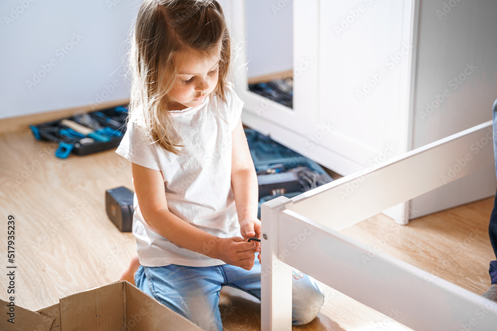 Dad,little girls daughters assemblle wooden baby bed according to ...