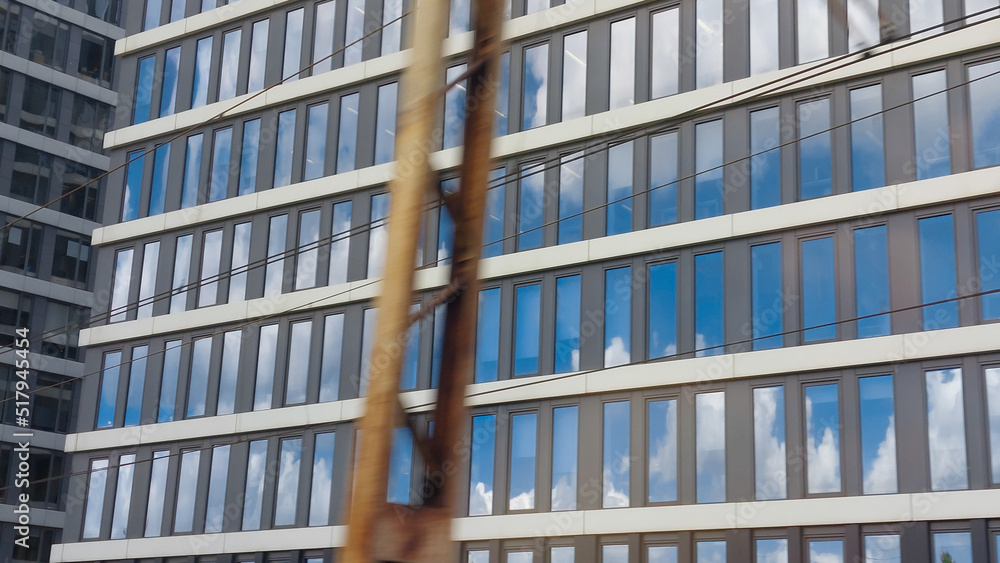 Skyscraper's windows reflecting sky disturbed by railway pole Stock ...