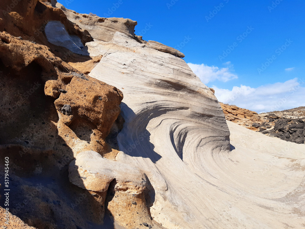 Steep volcanic sand rocks under blue sky. Rock formations and Lunatic ...
