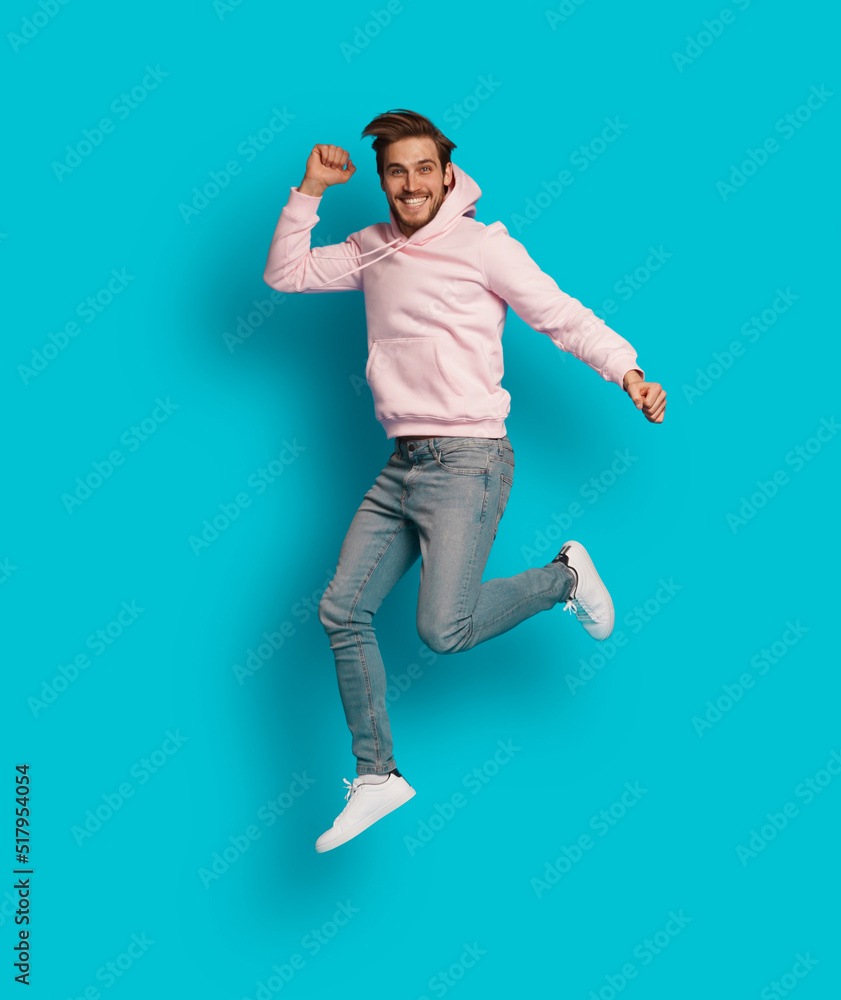 Full size photo of young happy excited smiling positive man jumping ...