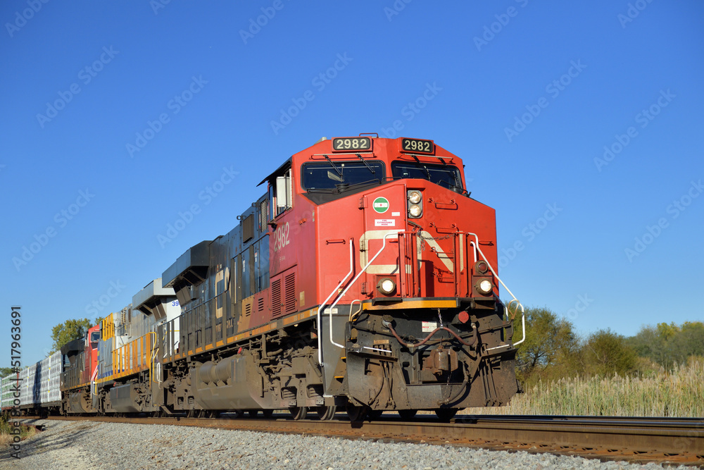Canadian National Railway locomotives lead a freight train through a ...