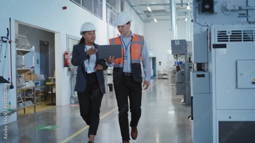 Two Professional Heavy Industry Engineers Walking at a Factory in ...
