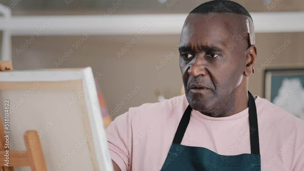Close up concentrated serious pensive talented elderly African male ...