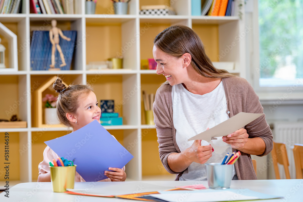 Stockfoto The teacher helping a child and they are working together ...