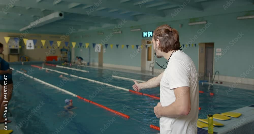 Coach practise with swimmer in the indoor swimming pool Stock Video ...