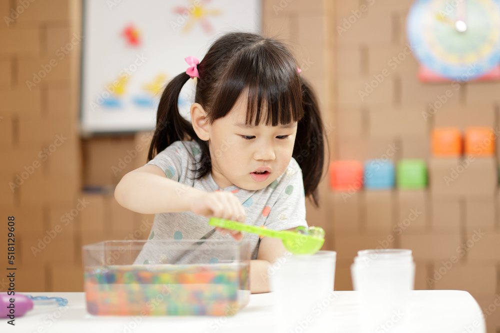 young girl play science experiments and fine motor skill for ...