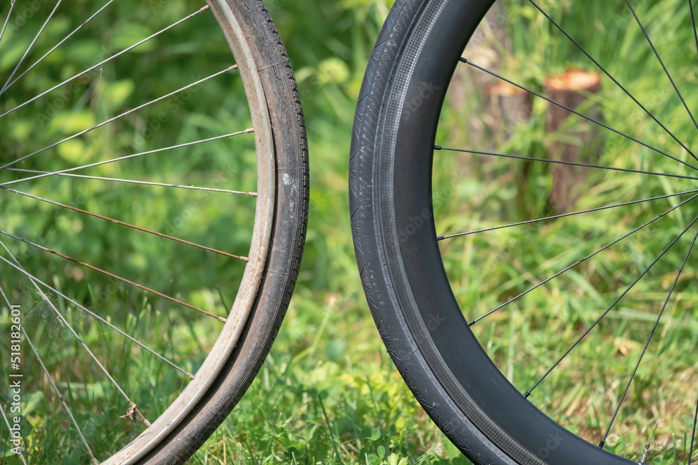 metal wheel of a old vintage bike and high profile black carbon wheel ...