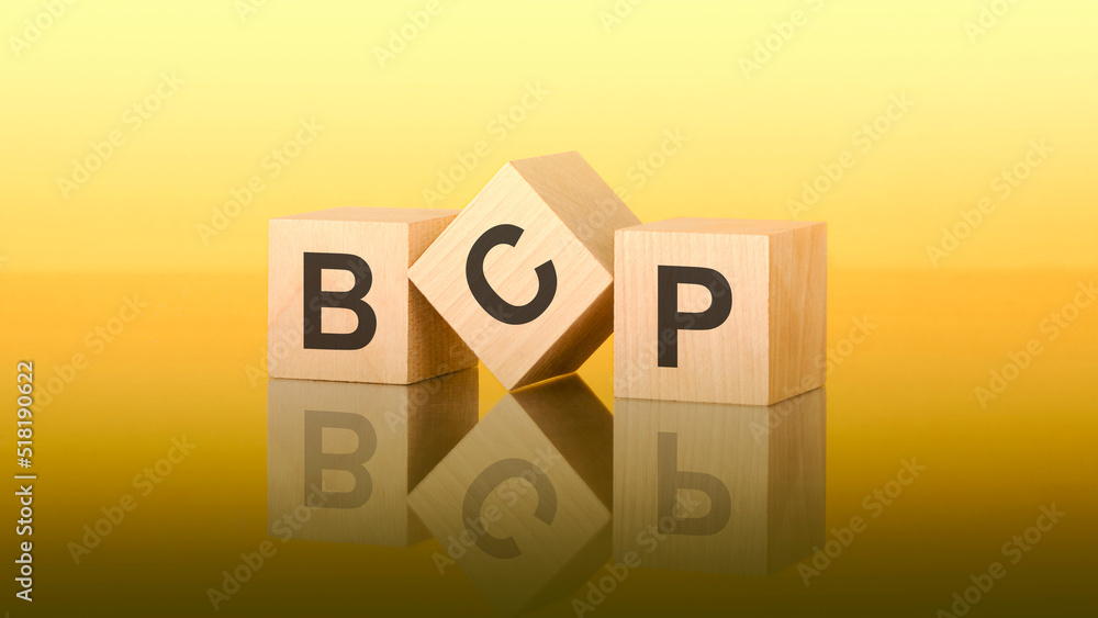 BCP - text written on wooden cubes, yellow background, concept Stock ...