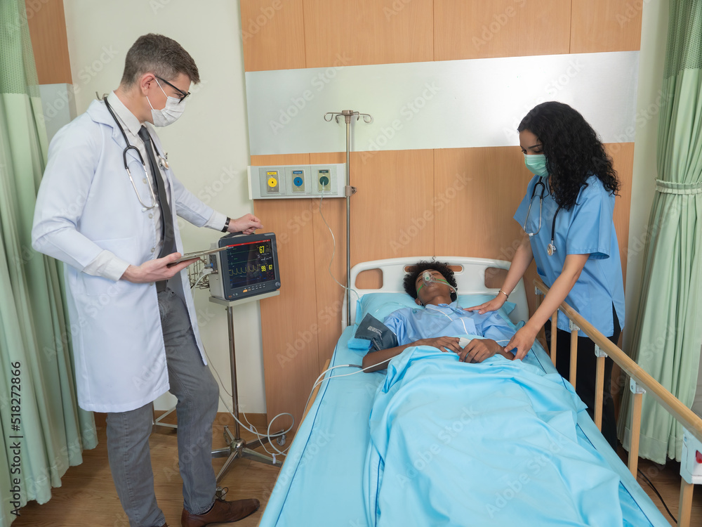 At hospital intensive care unit patient in coma lay on bed ...