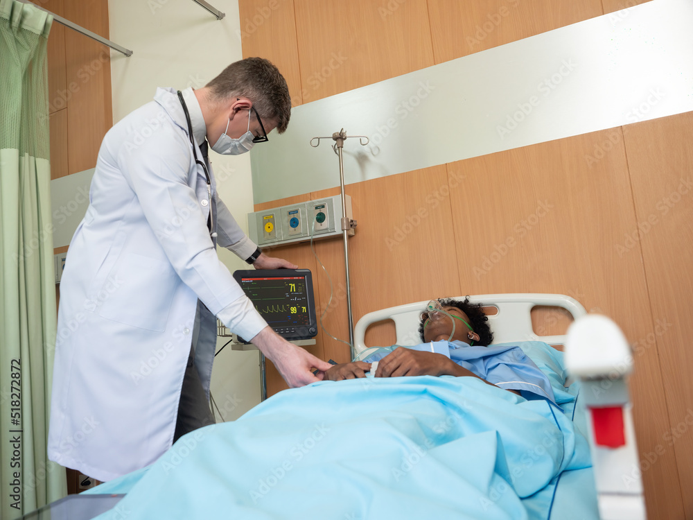 At hospital intensive care unit patient in coma lay on bed ...