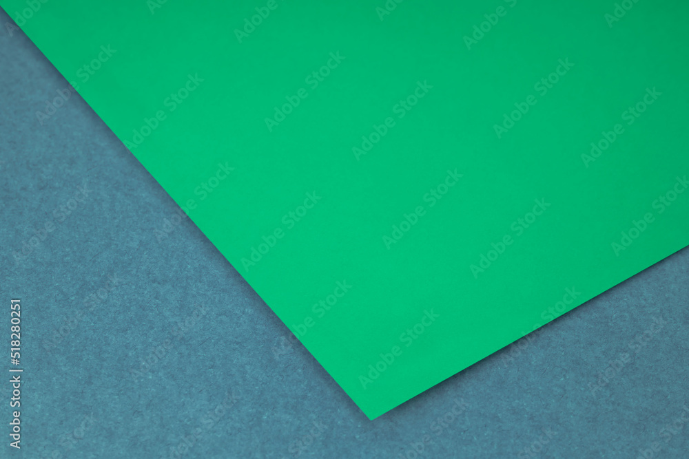 Plain green paper sheet lying on blue grey textured Background like an ...