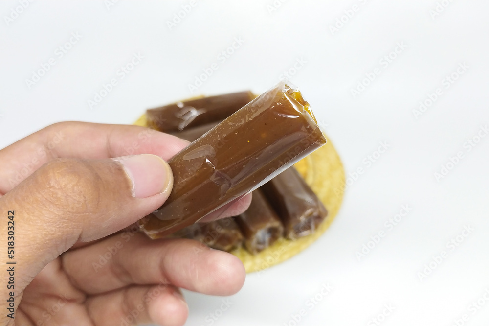 Dodol in hand. Dodol is a traditional snack from Indonesia with a sweet ...