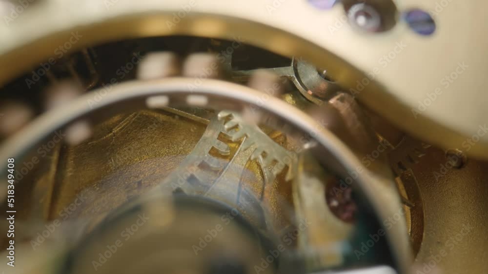 Moving gold gears inside working pocket watch mechanism. Working clock ...