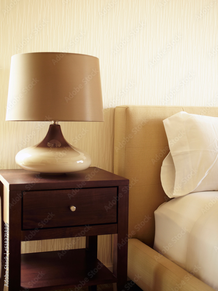 Bedside nightstand and lamp in bedroom Stock Photo | Adobe Stock