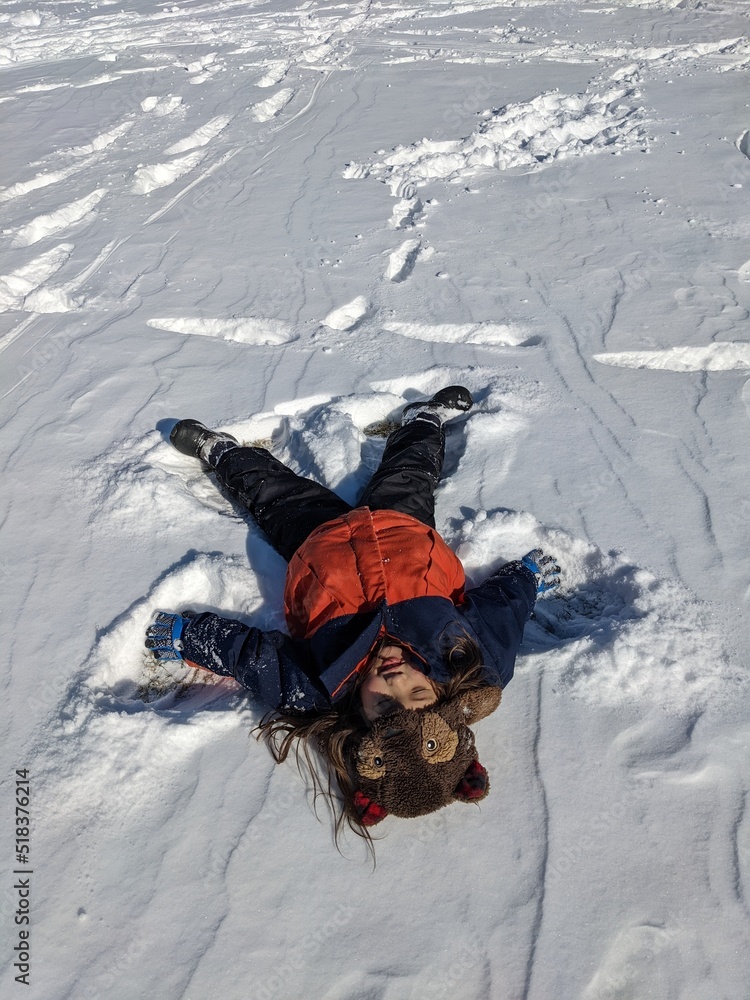 Making a snow angel Stock Photo | Adobe Stock