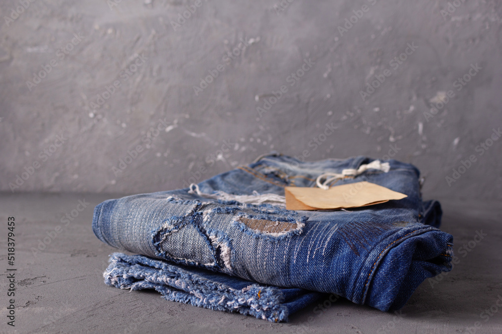 Paper price tag label on jeans background texture. Blue jeans denim ...