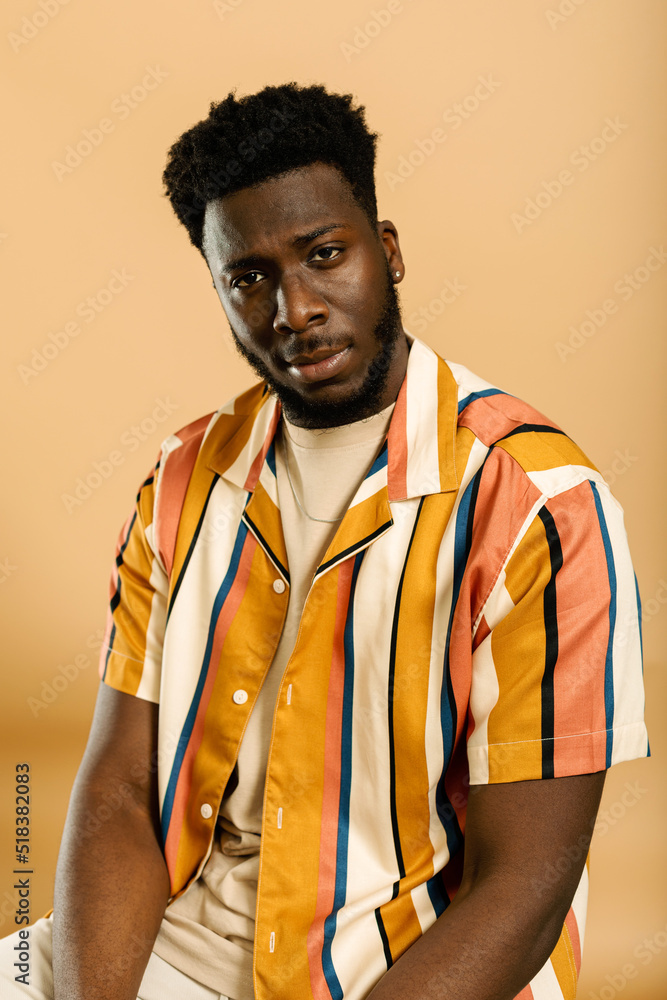 Cool black man in striped shirt summer studio portrait Stock Photo ...
