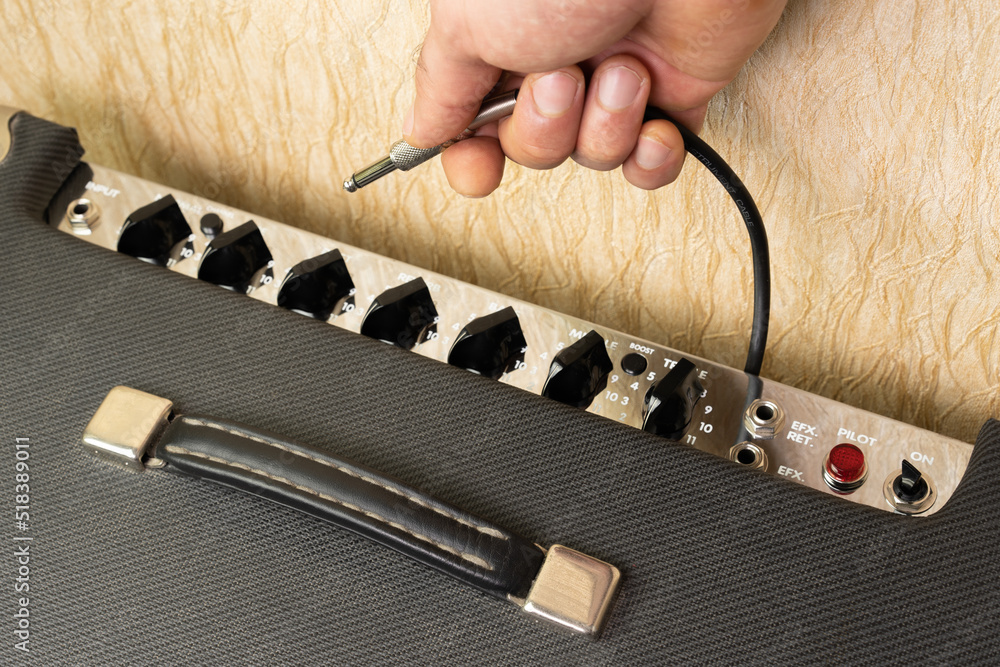 Connecting a cable with a jack connector to a combo amplifier Stock ...