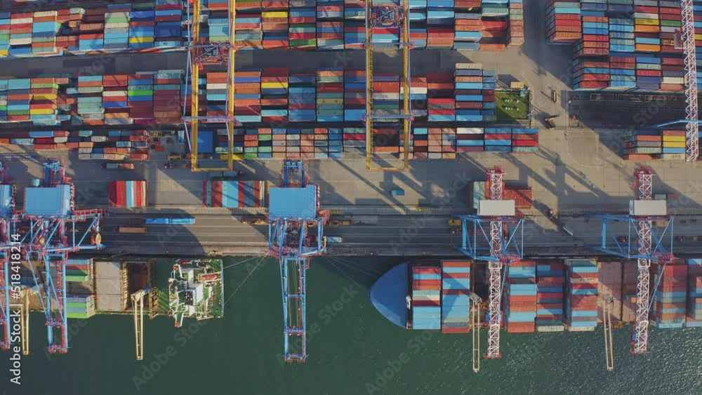 Loading and unloading a container ship in the port at the pier. Aerial ...