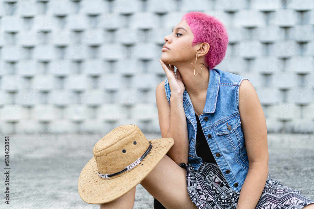 Beautiful young woman sitting on the ground outside. Stock Photo ...