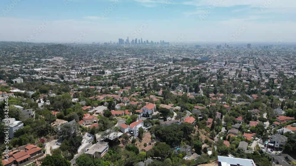 An elevated view over large homes in Hollywood Hills is shown, with ...