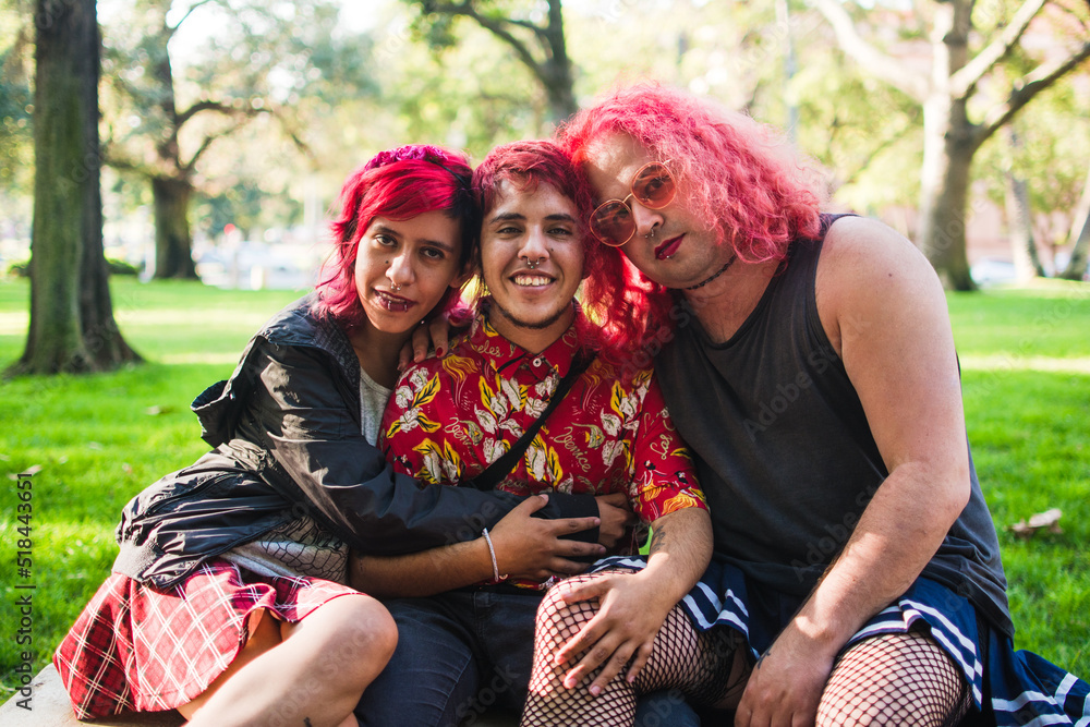 Trans woman, trans man and non binary person hugging each other Stock ...