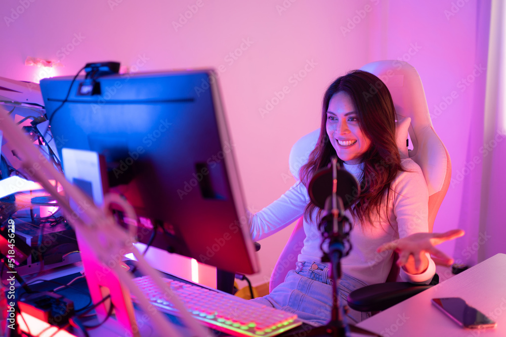 Happy young Asian transgender professional gamer wearing a gaming ...