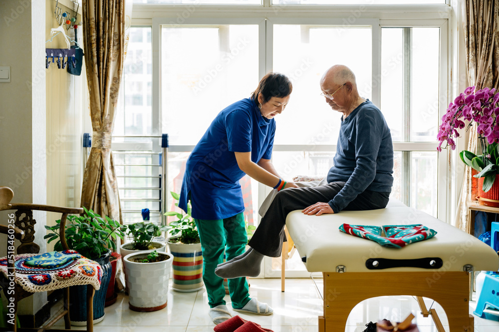 Physical therapist helping senior man patient Stock Photo | Adobe Stock