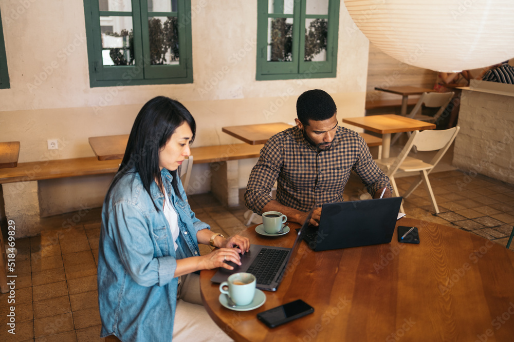 Co-workers working remotely in an alternative workspace Stock Photo ...